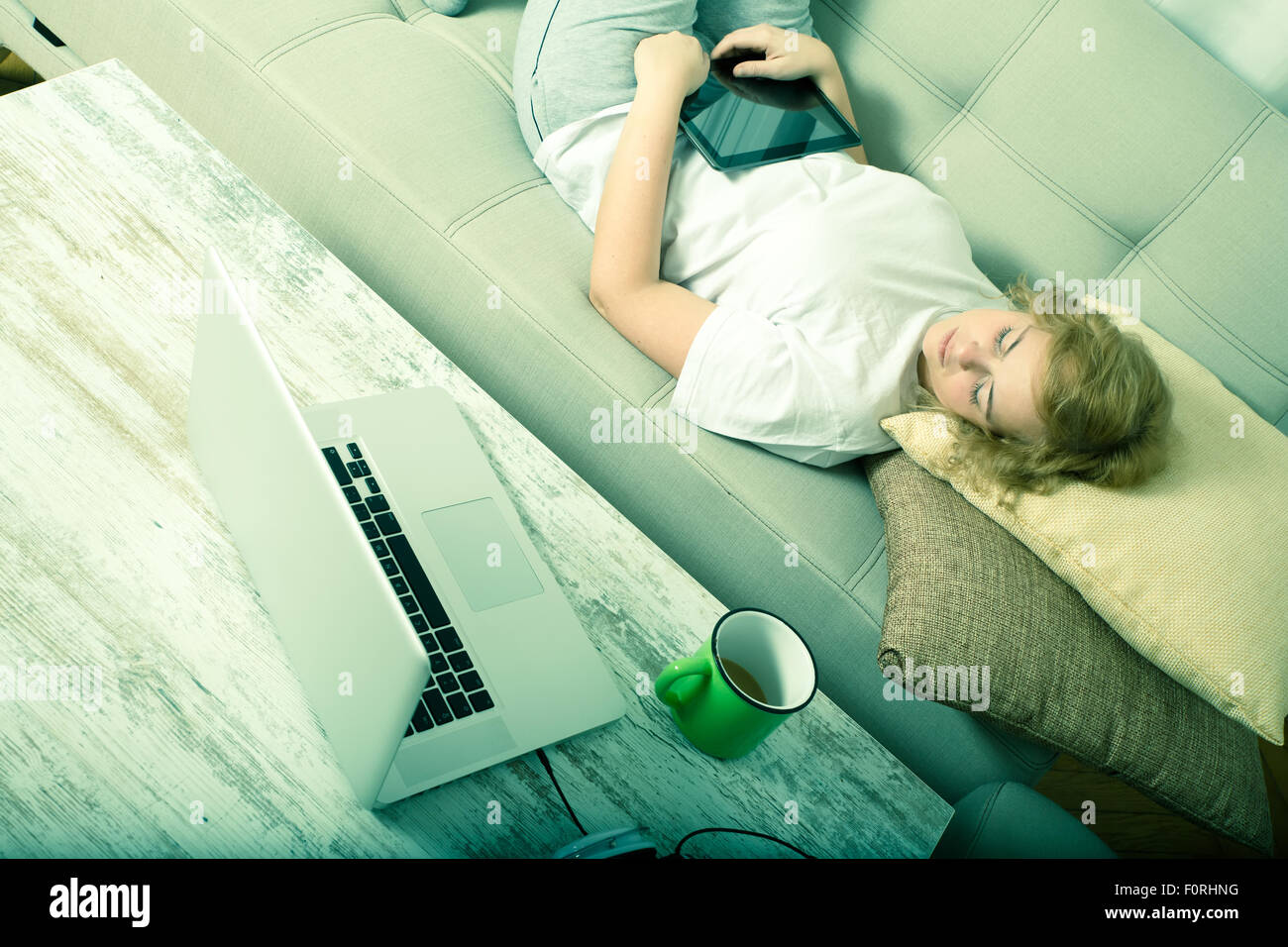 A young plus size woman fallen asleep in the living room in front of ...
