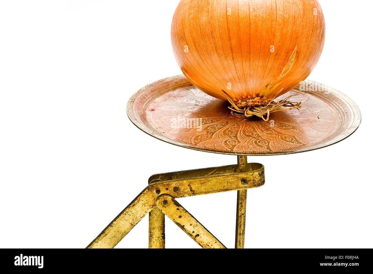 Onion on old rustic scale plate isolated on white Stock Photo - Alamy