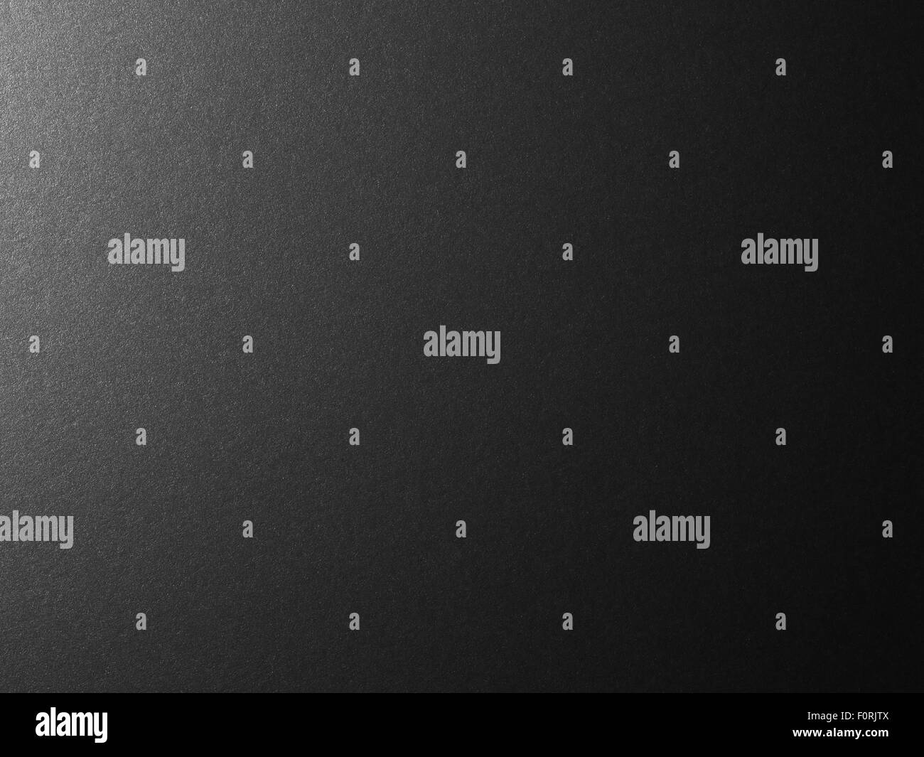 shot of surface with a metallic texture with light falling off to ...