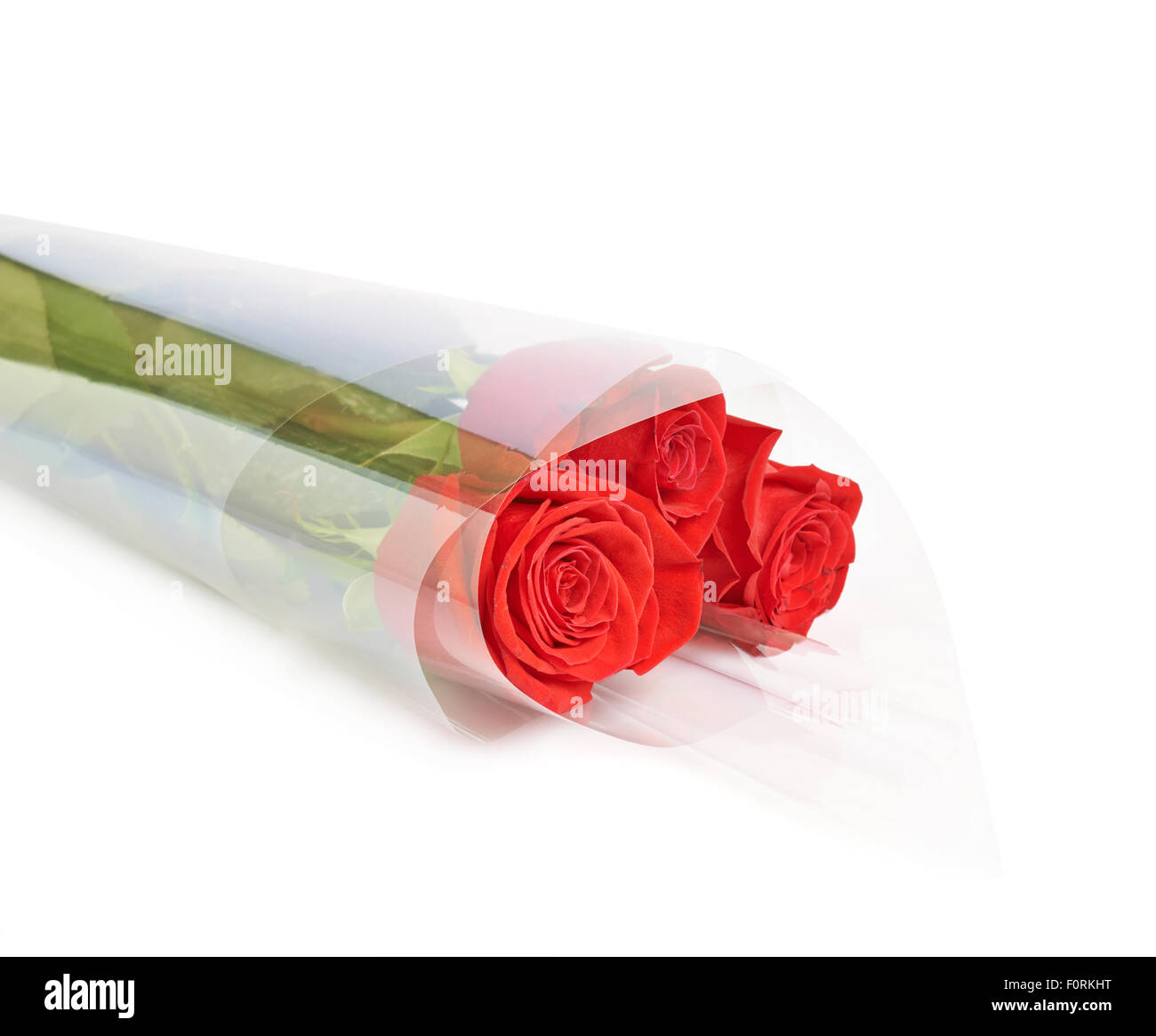 Three red roses in a wrapping Stock Photo - Alamy