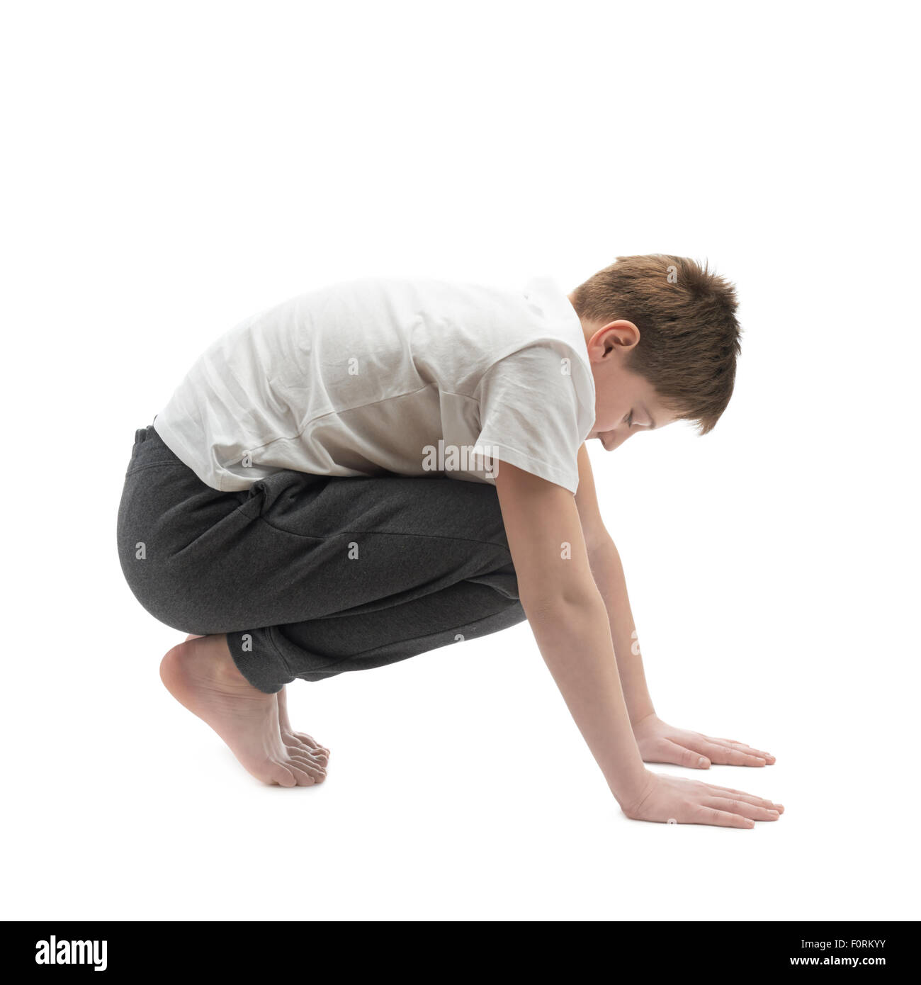 Young boy stretching or doing yoga Stock Photo - Alamy