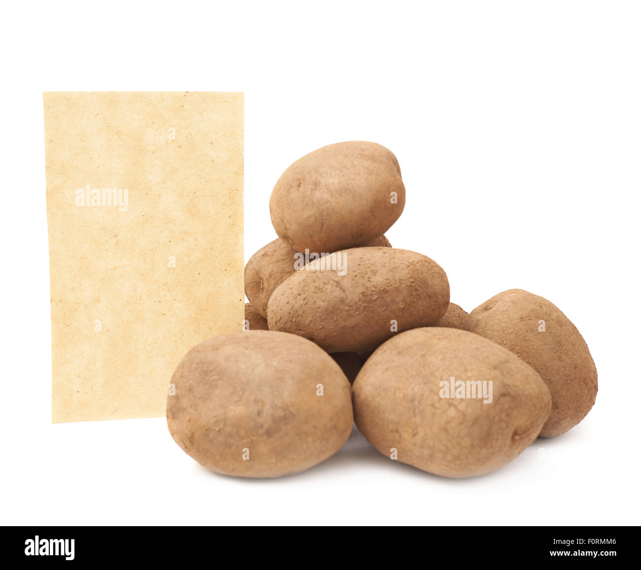 Pile of potatoes against piece of paper Stock Photo - Alamy