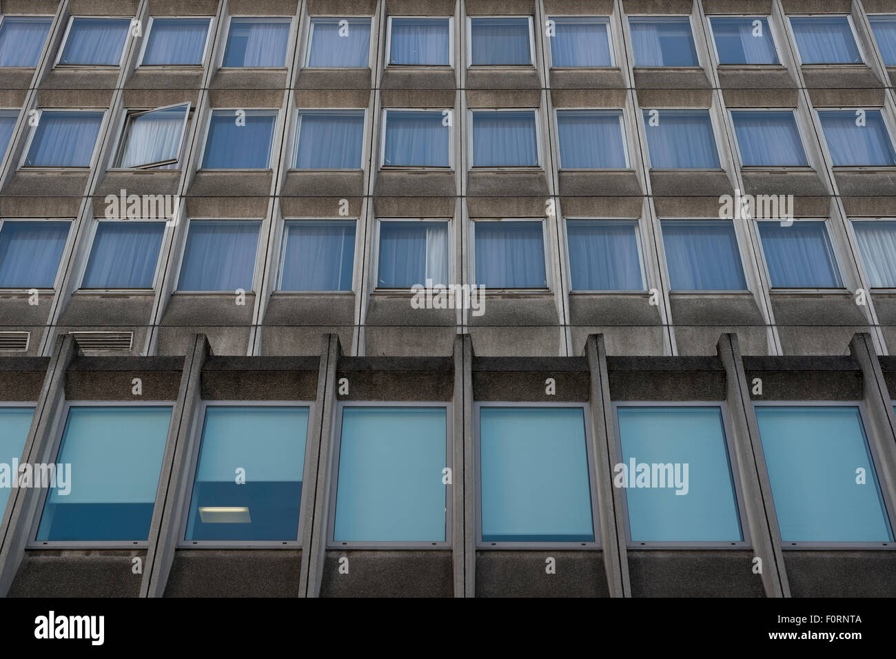 Glass and concrete building with one window open Stock Photo - Alamy