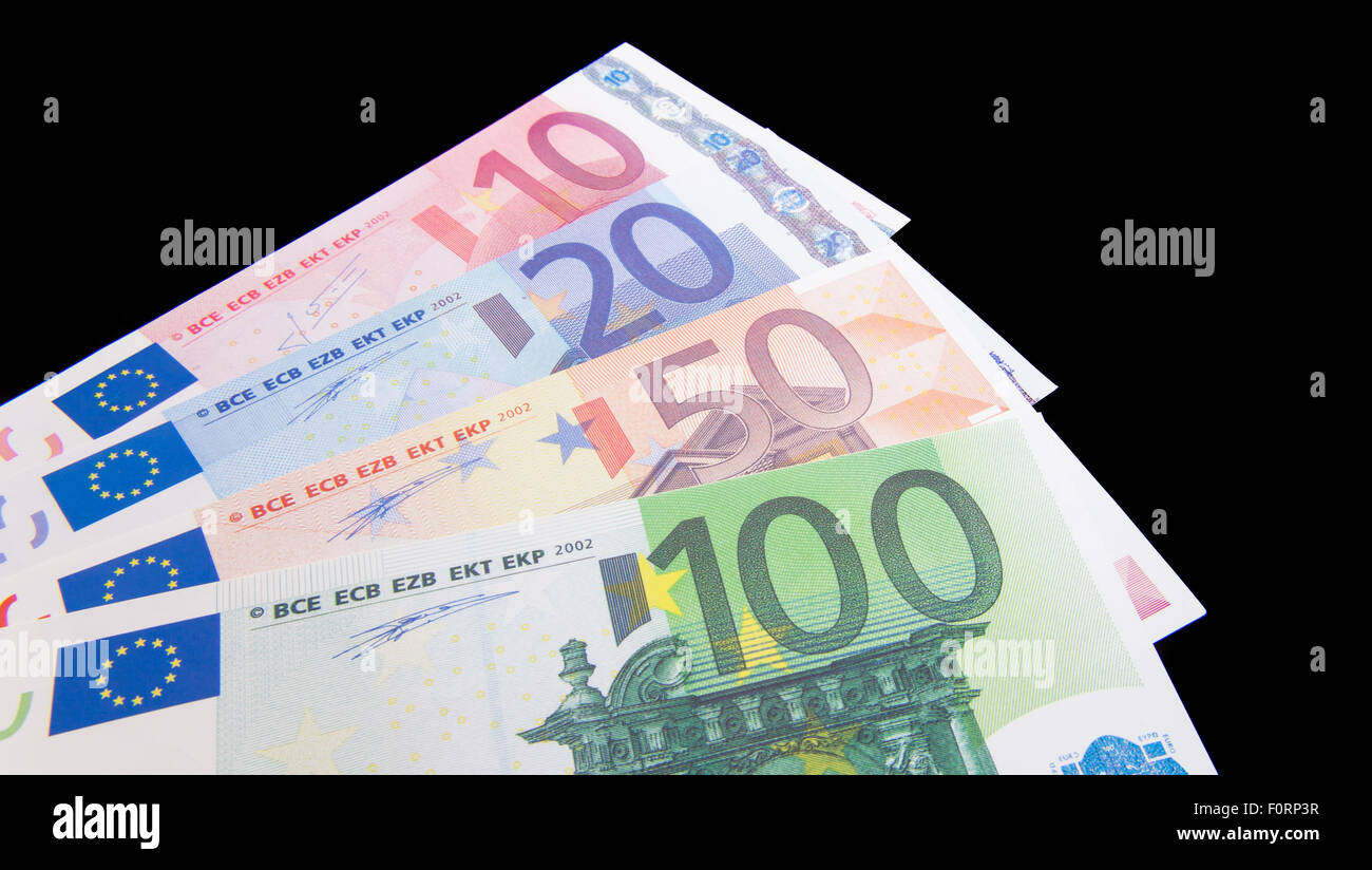 Various euro notes on black background Stock Photo - Alamy