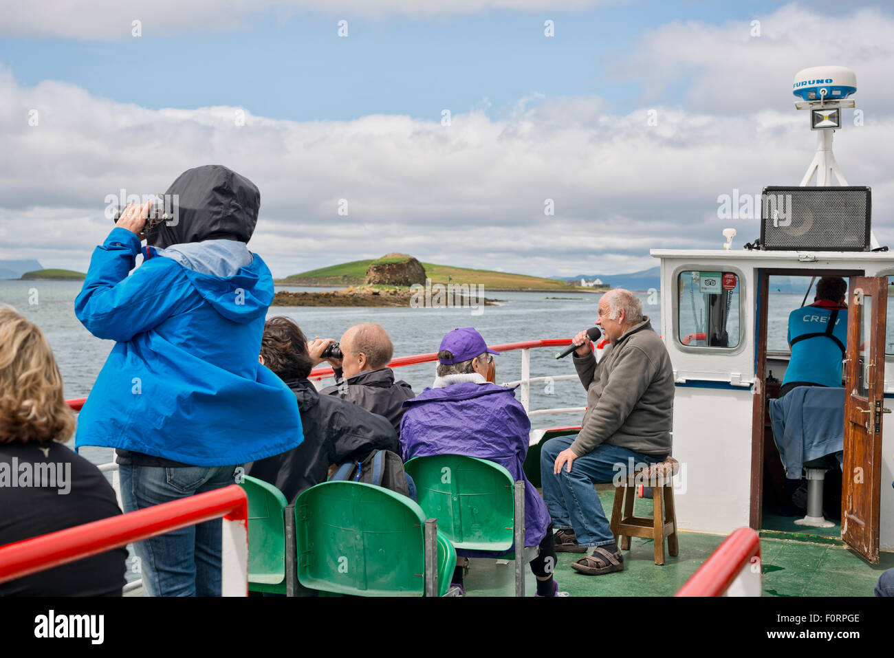 A guide speaking into microphone on a boat trip around Clew Bay near ...