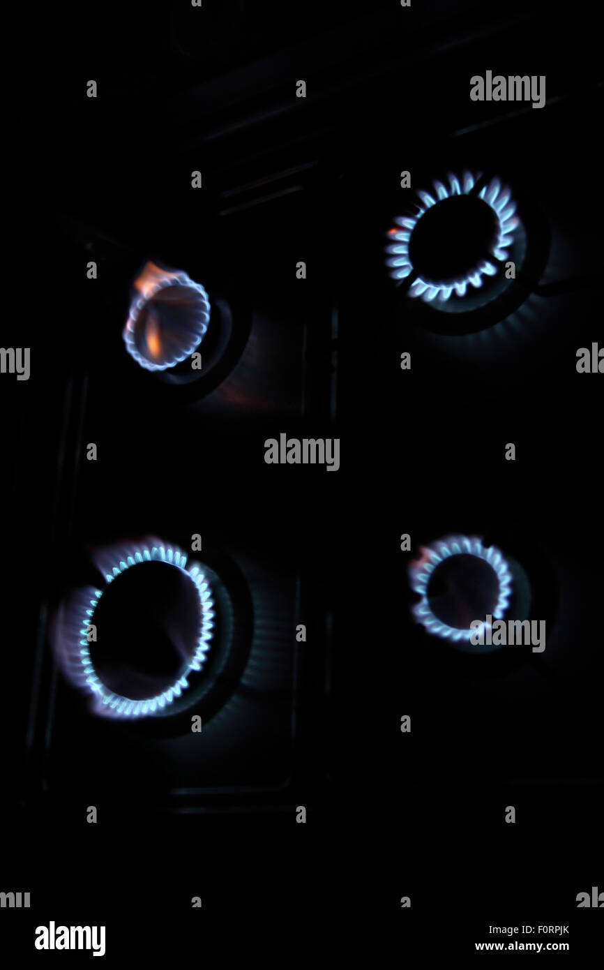 four flame a gas stovel in home cooking Stock Photo - Alamy
