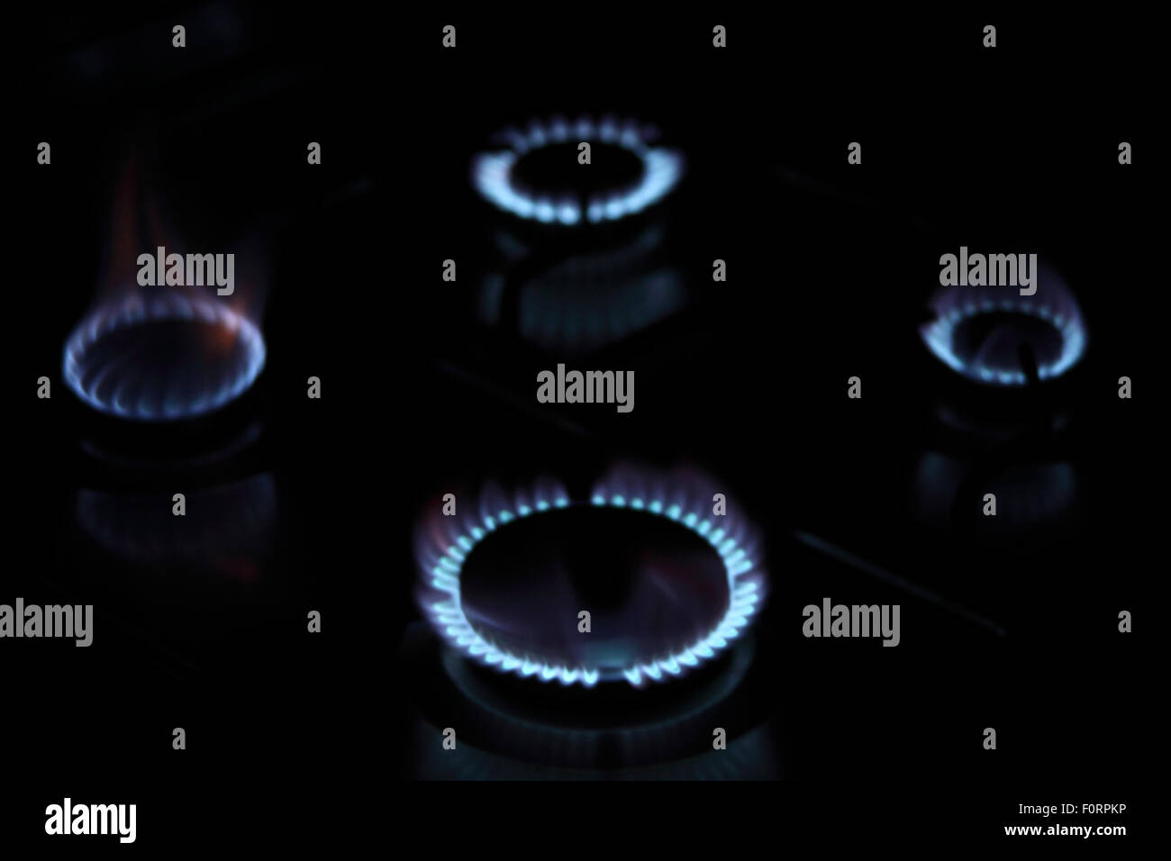 four flame a gas stovel in home cooking Stock Photo - Alamy