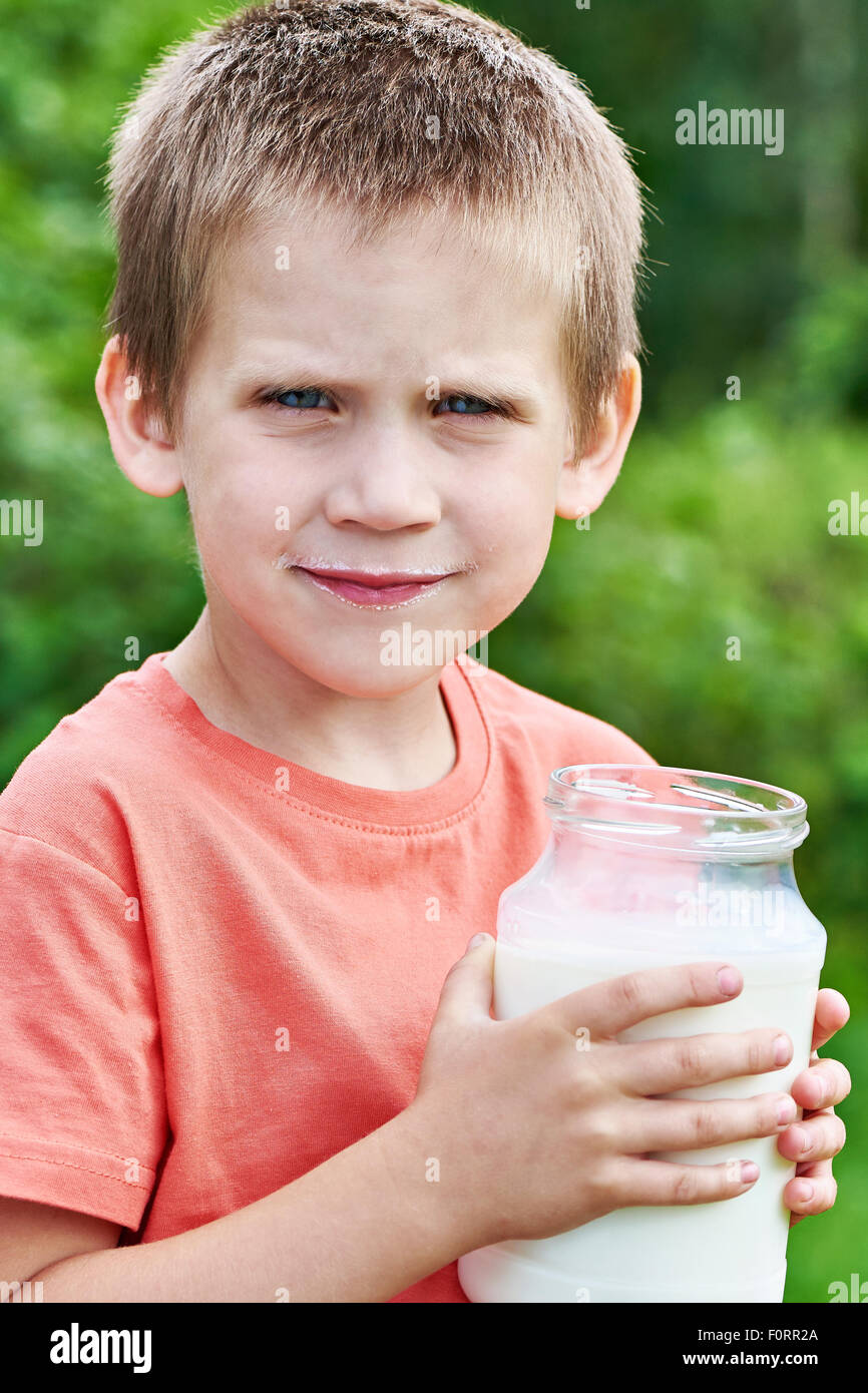 Boy with glass jar of fresh milk in summer day Stock Photo - Alamy