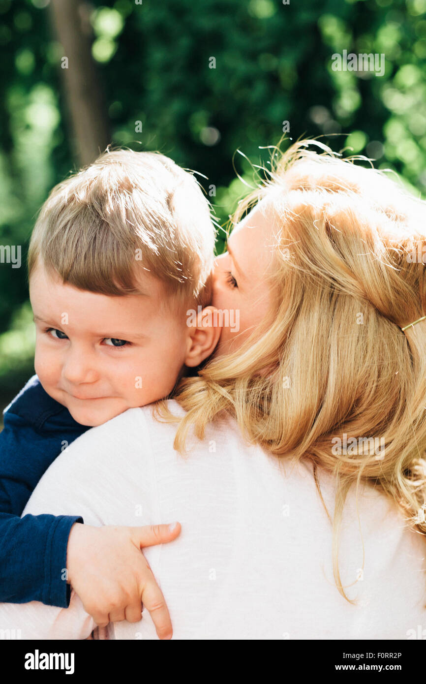 Child happily hugging mother outdoors Stock Photo - Alamy