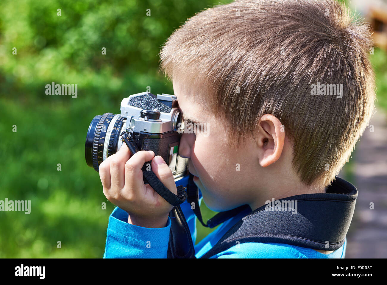 Little boy with retro camera shooting outdoors Stock Photo - Alamy