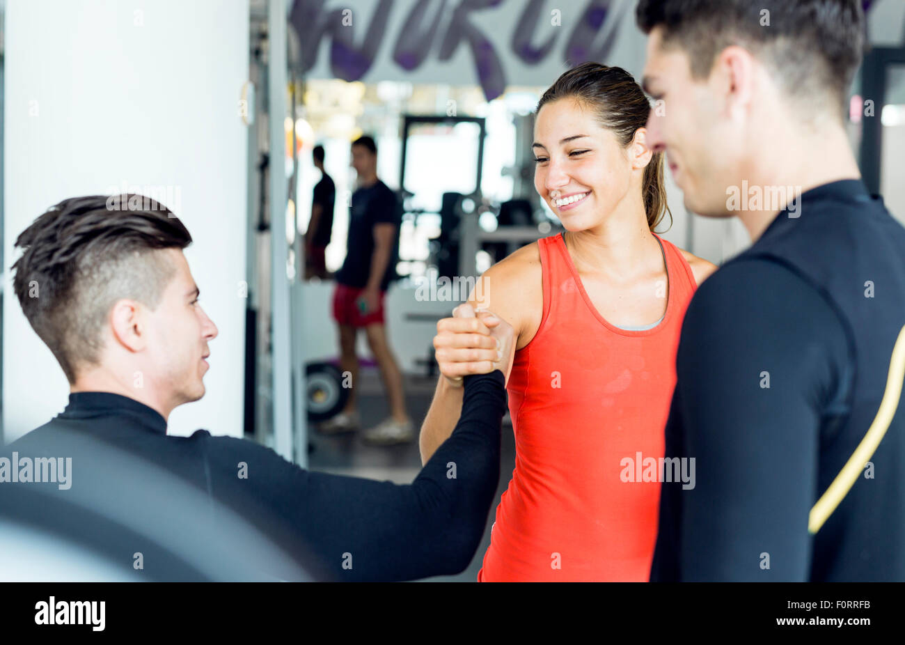 Group of positive young people shaking hands and talking happily Stock ...