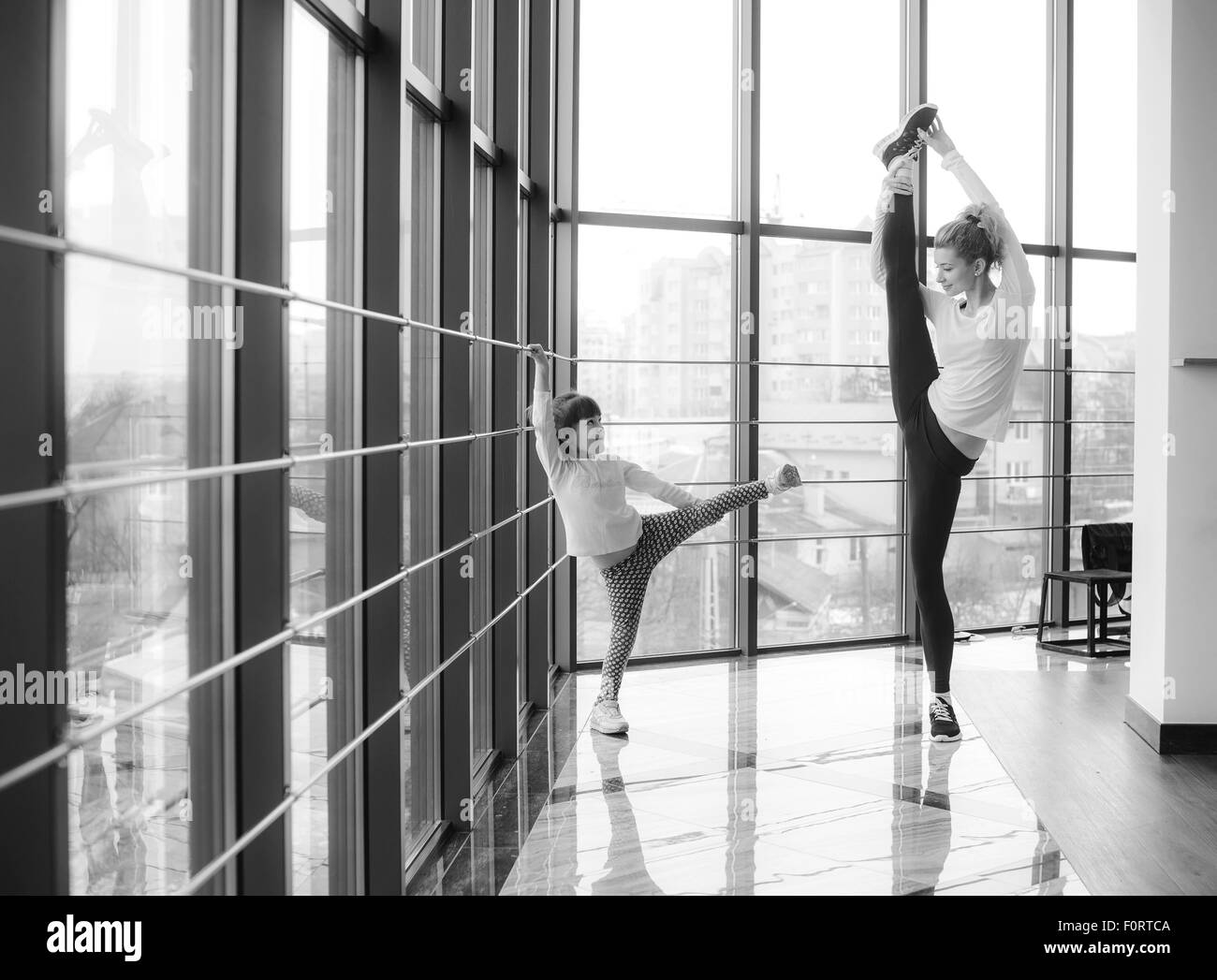mother-learning-daughter-to-make-a-high-leg-strech-stock-photo-alamy