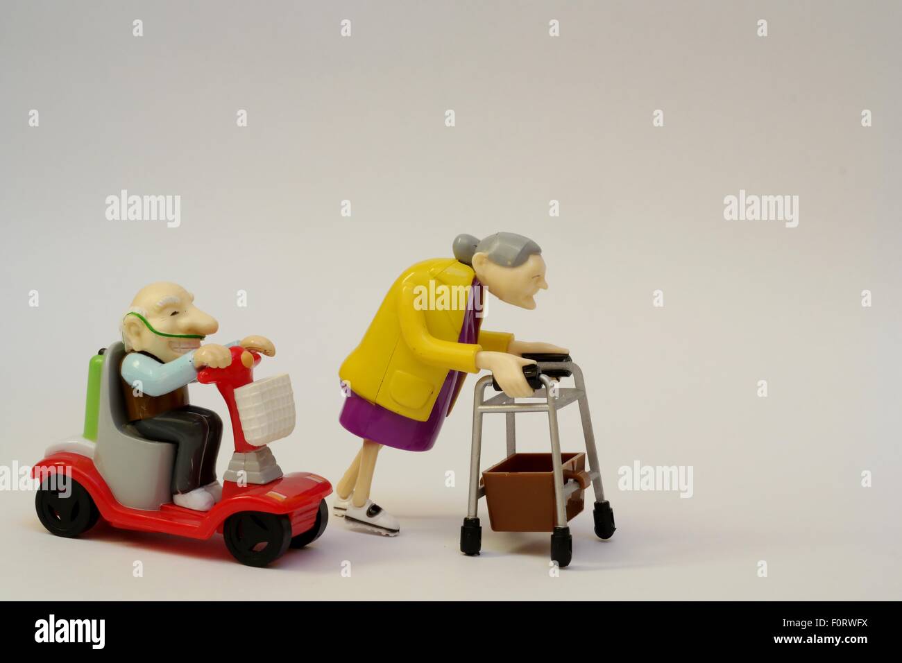 Elderly male and female toy/cartoon figures on neutral background ...