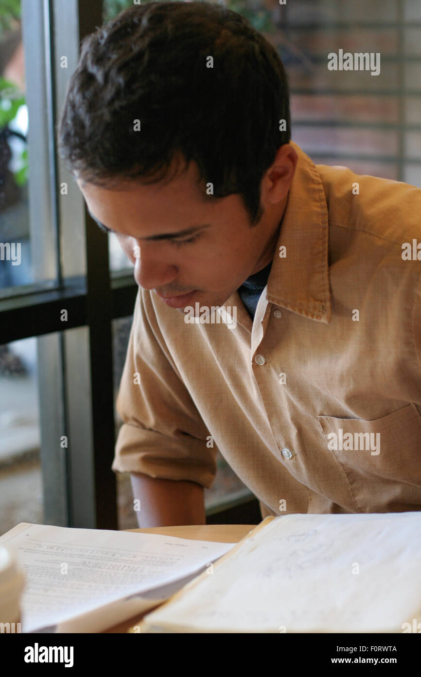 Student studying reading paper Stock Photo - Alamy