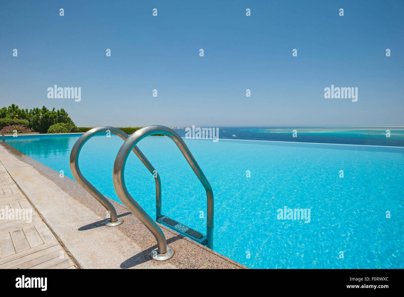 View from a luxury infinity swimming pool with tropical sea outlook ...