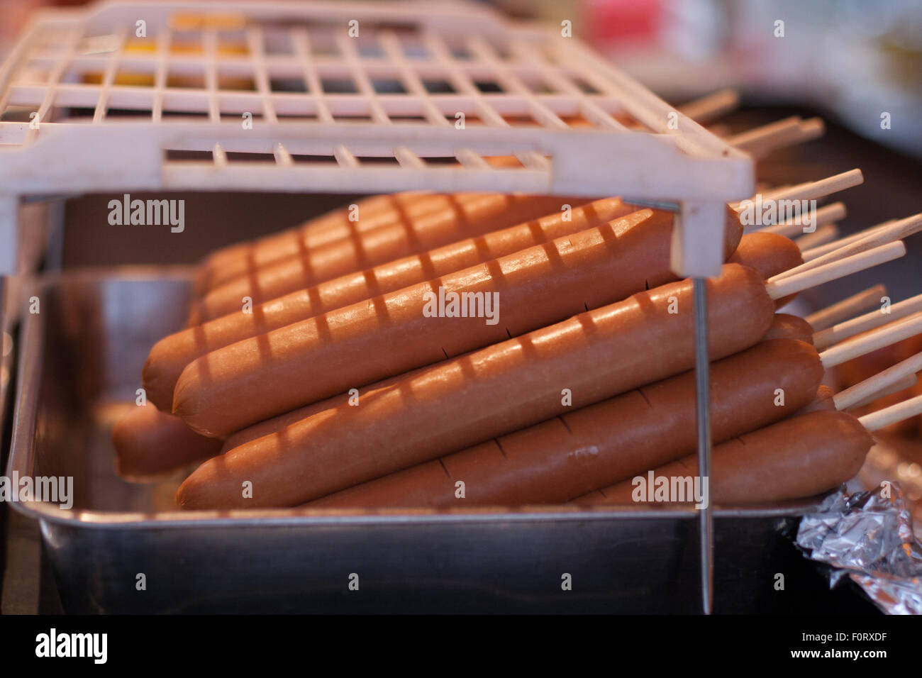 Hot dogs on sticks stacked in pan Stock Photo - Alamy