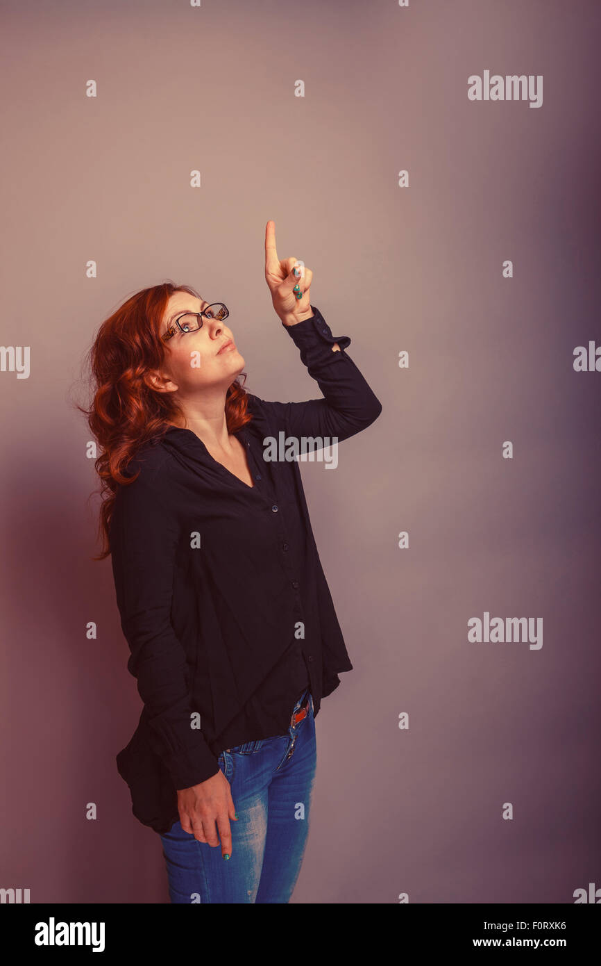 European - looking woman of 30 years is pointing in the direc Stock ...