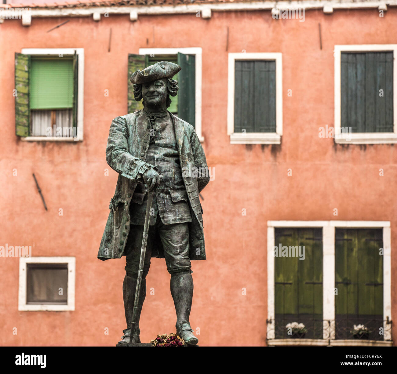 The Statue of a Famous Venetian stands proud on his plinth smiling ...