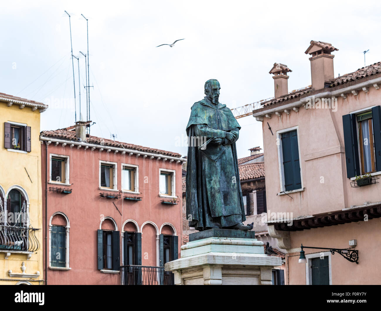 The statue of a famous Venetian stands looking down on a piazza Stock ...