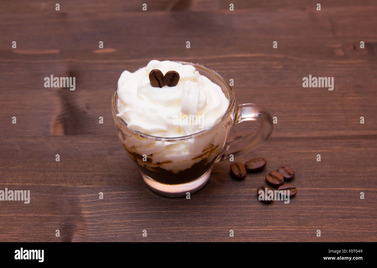 Cup with coffee and cream on wooden table Stock Photo - Alamy