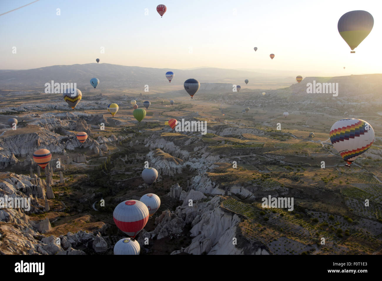 Balloon flying over Cappadocia, Turkey at sunrise Stock Photo - Alamy