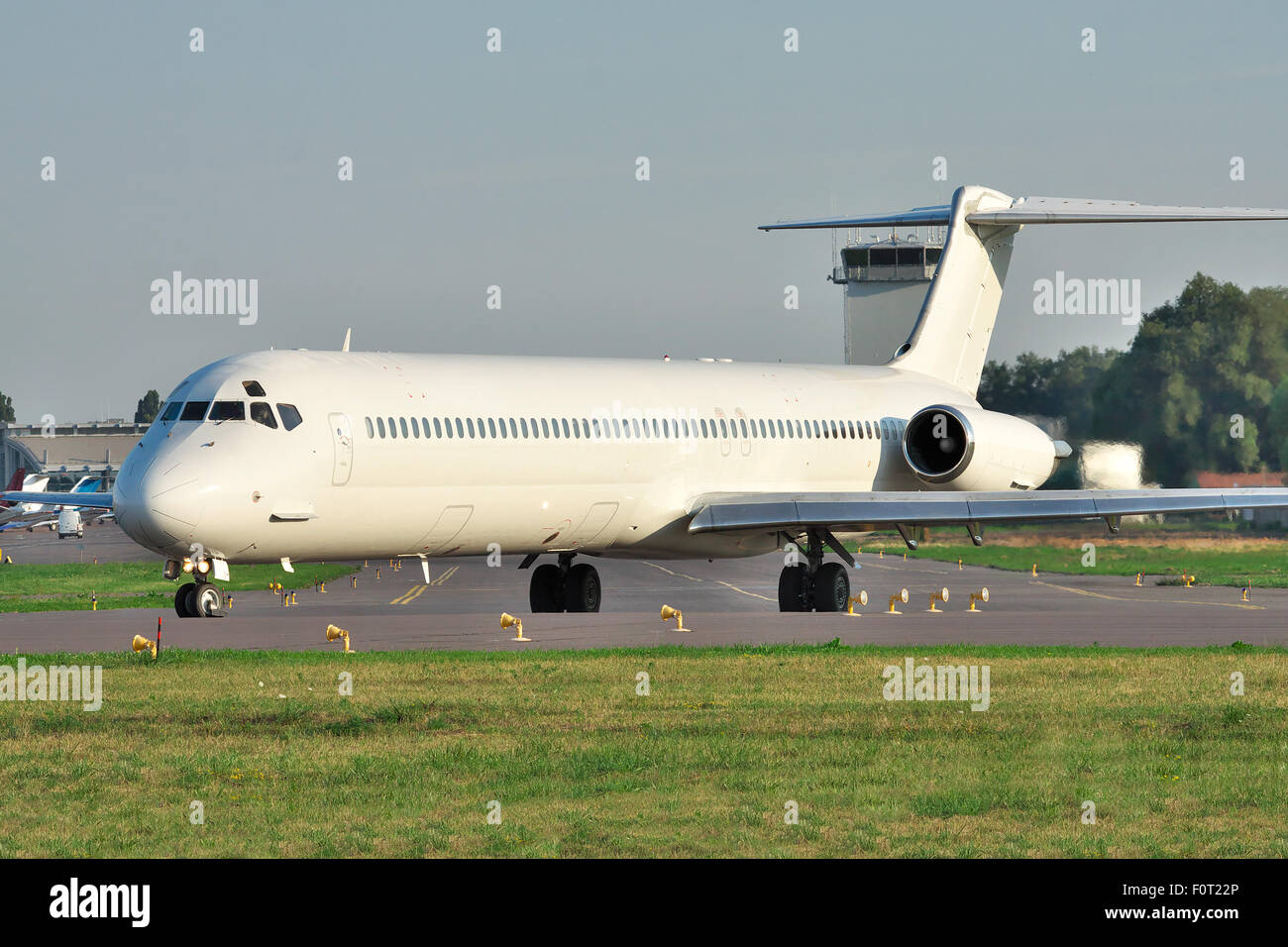 White passenger plane on the runway in the airport Stock Photo - Alamy