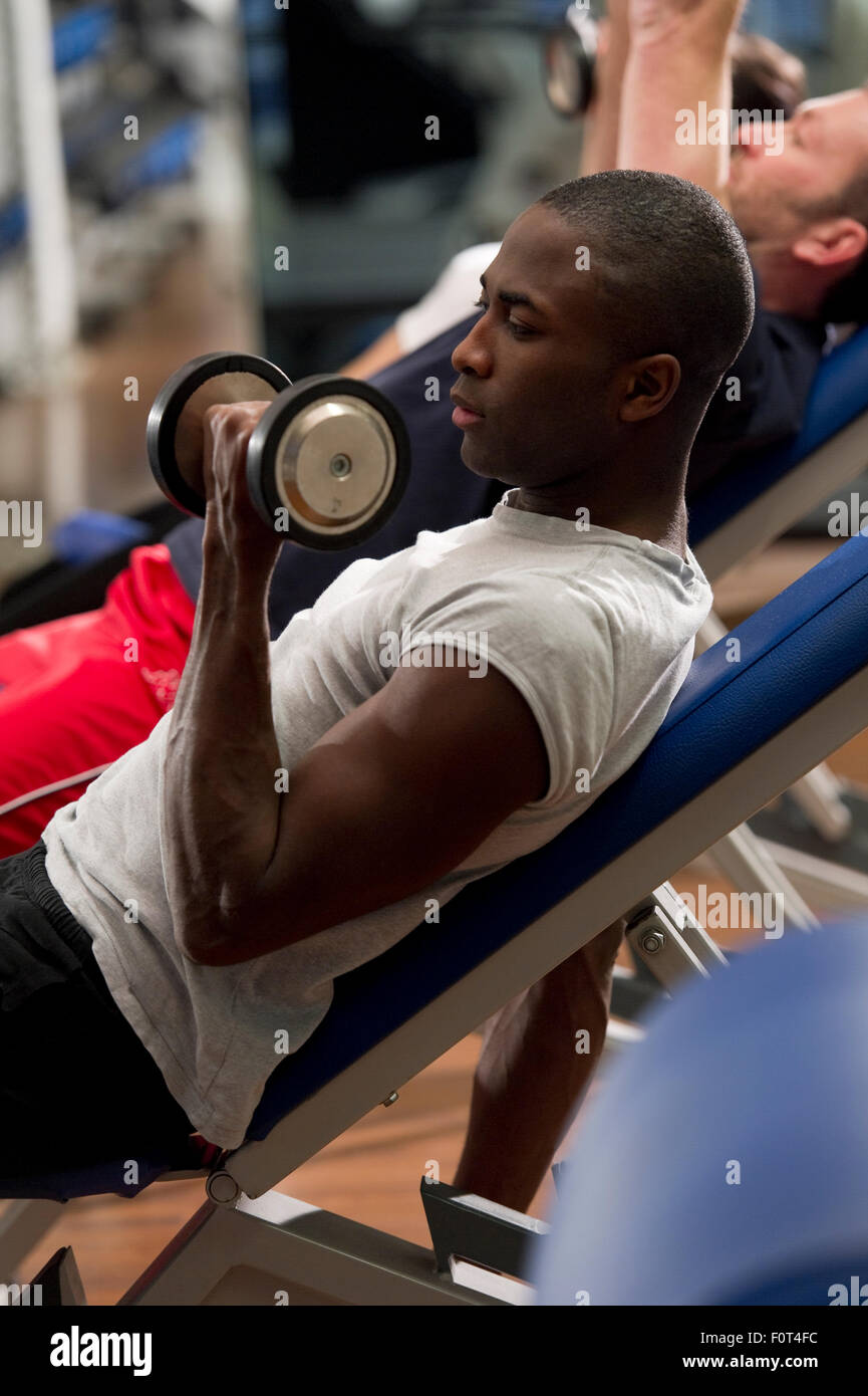 People working out with weights at health club Stock Photo - Alamy