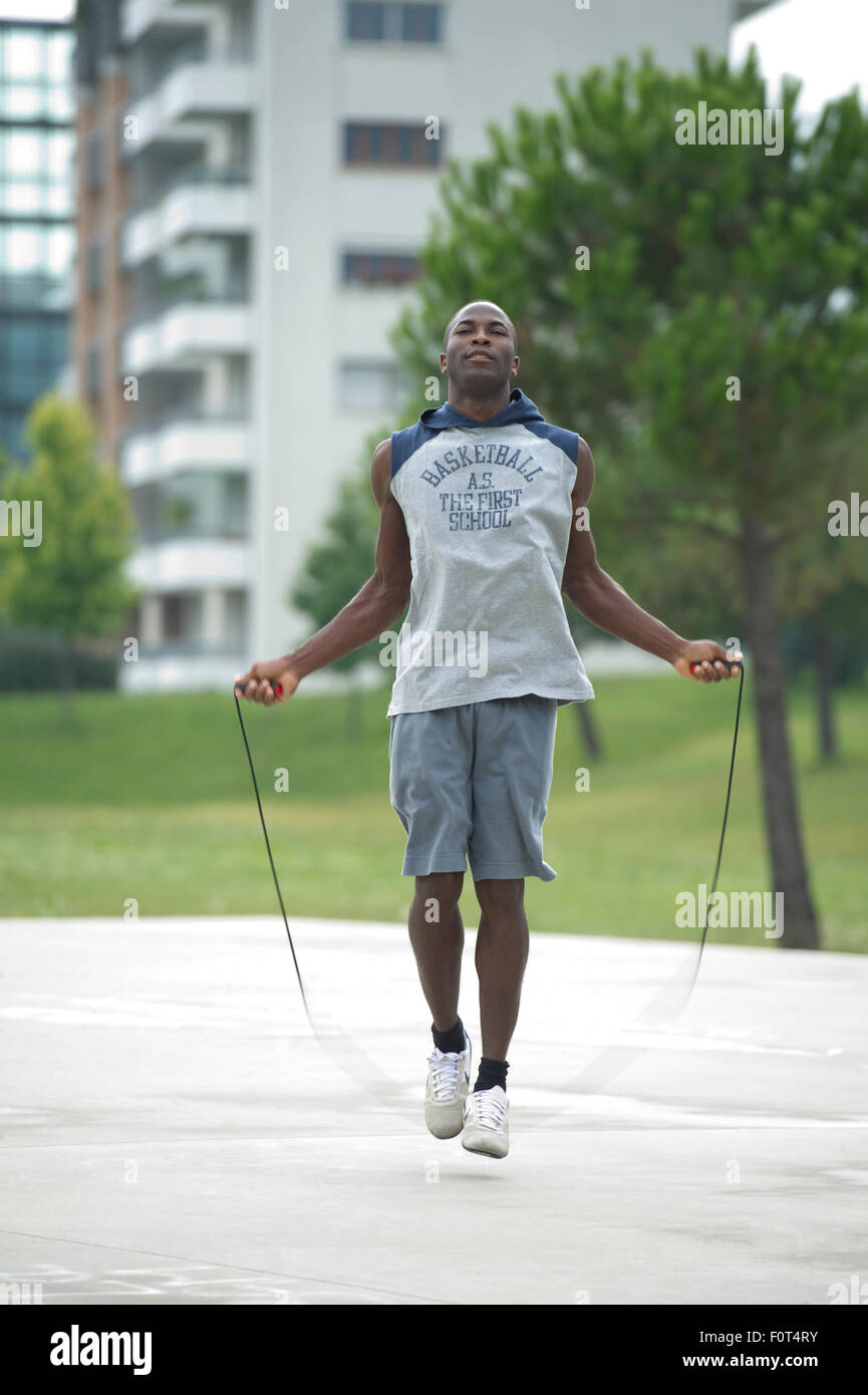 Young man jumping rope outdoors Stock Photo - Alamy