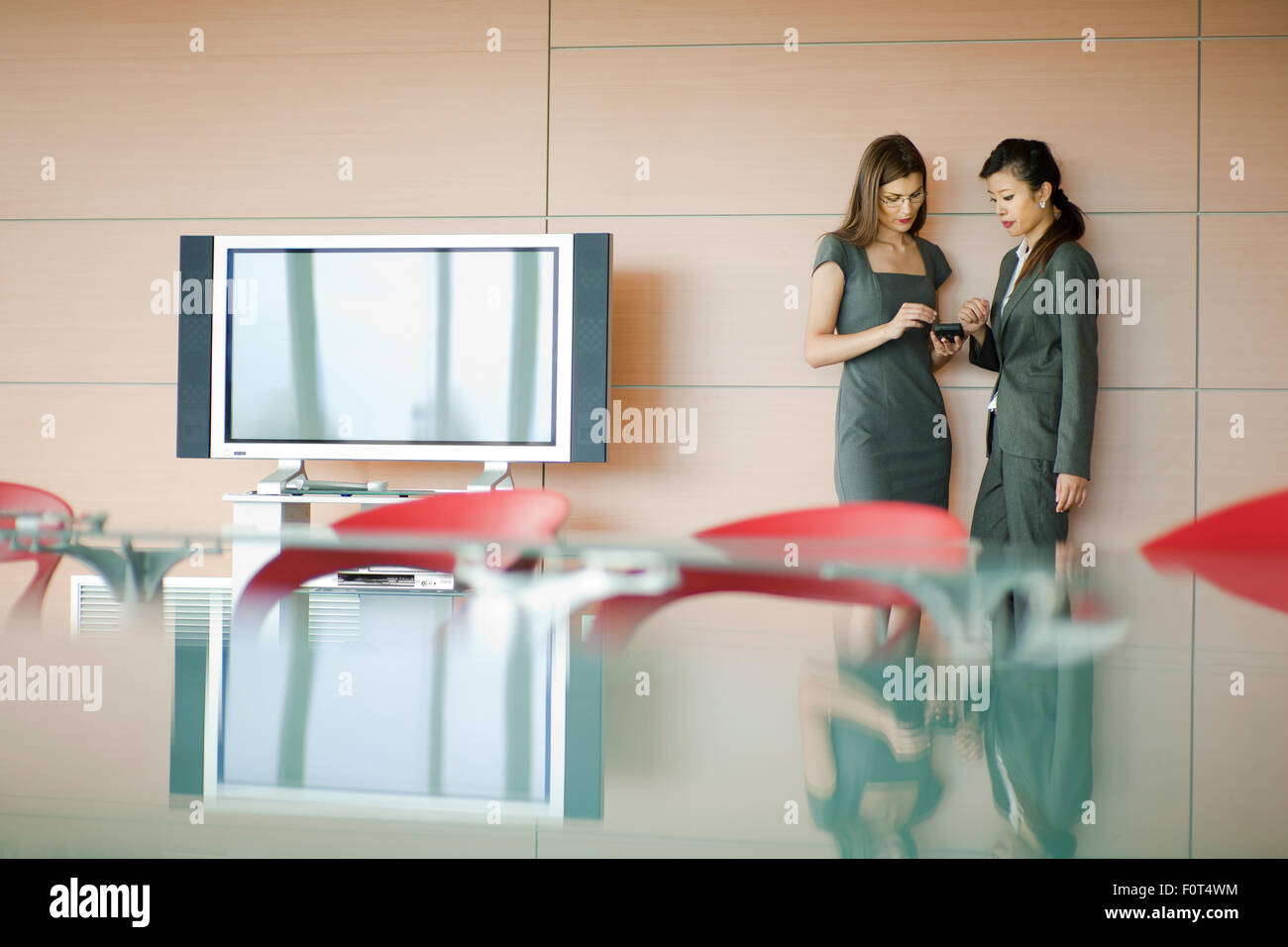 Two businesswomen speaking office desk hi-res stock photography and ...