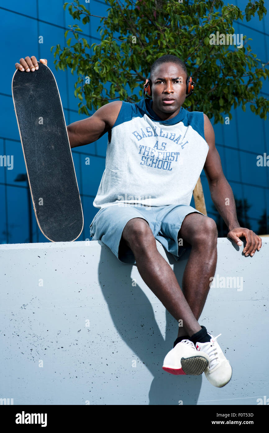 Young skateboarder taking a rest Stock Photo - Alamy