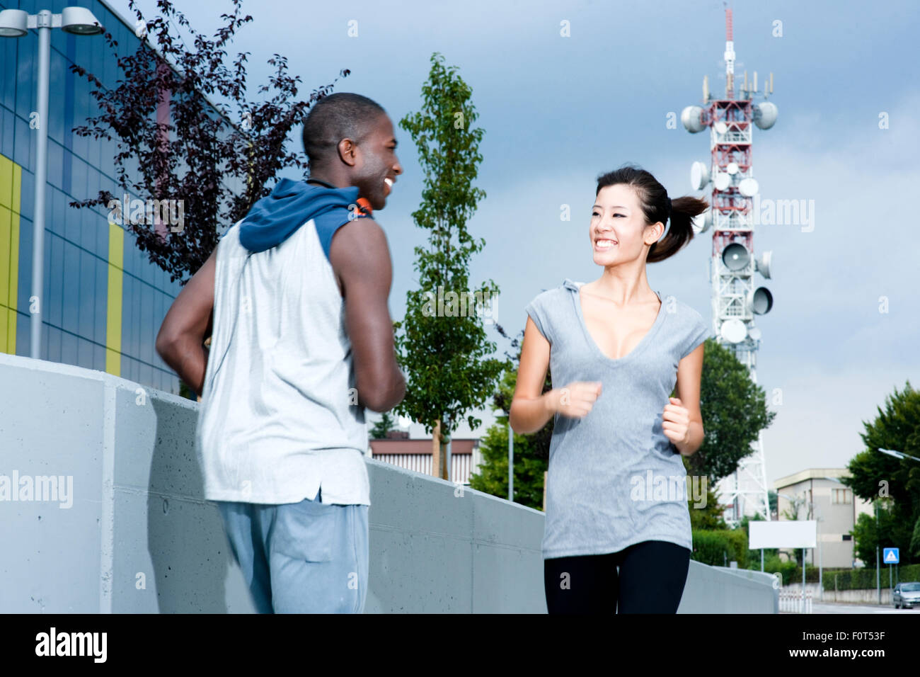 Two young people jogging Stock Photo - Alamy