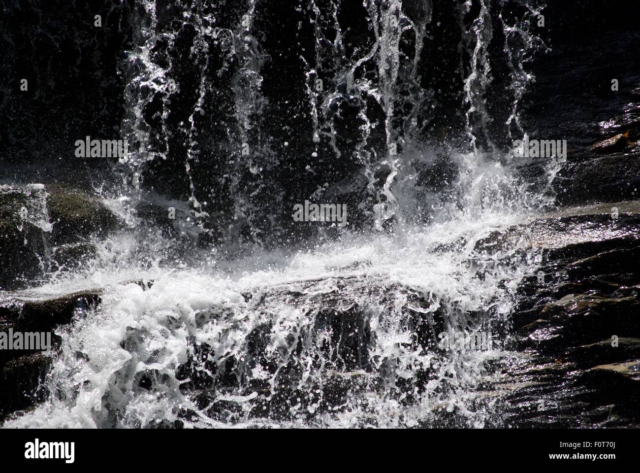 Close-up of a waterfall. Water hitting rocks Stock Photo - Alamy