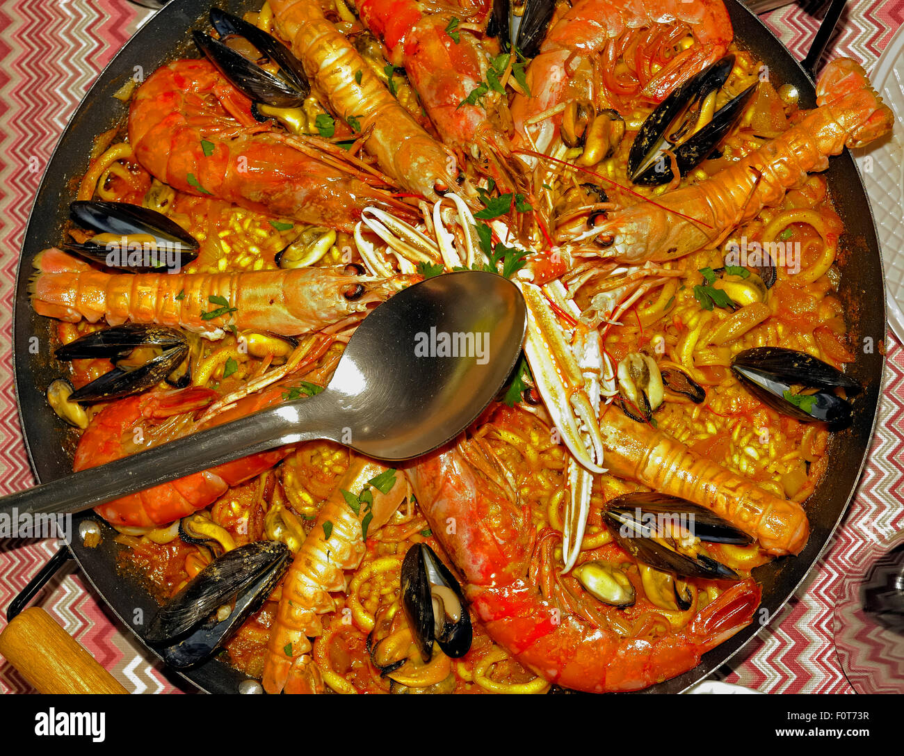Traditional Spanish seafood paella dish with spoon Stock Photo - Alamy