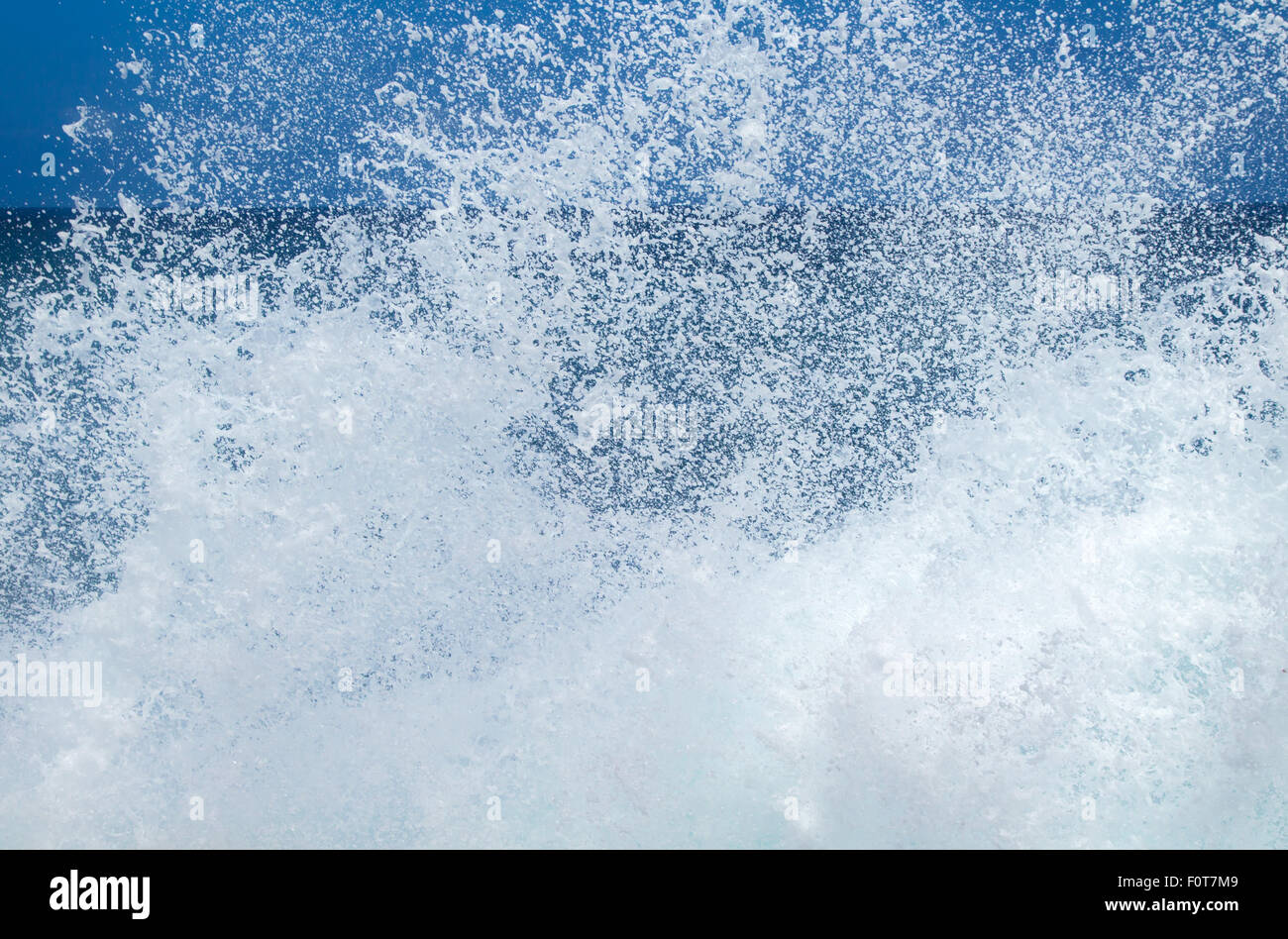 sea water foam flying against the backdrop of blue water Stock Photo ...