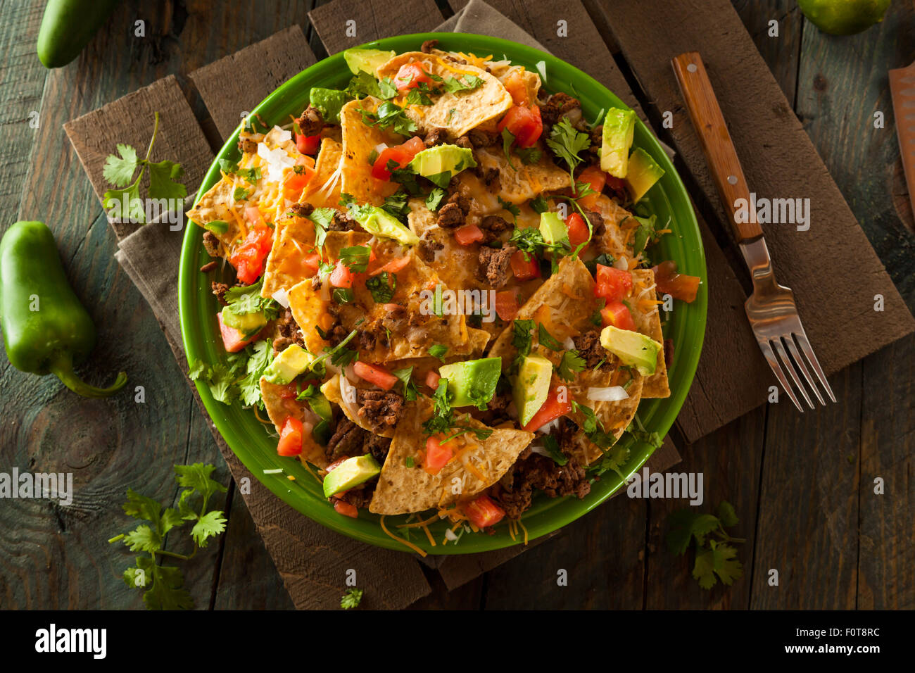 Loaded Beef and Cheese Nachos with Cilantro and Lime Stock Photo - Alamy
