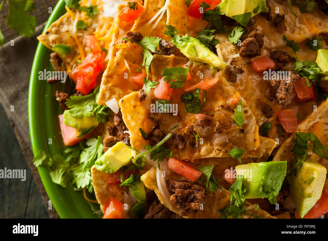 Loaded Beef and Cheese Nachos with Cilantro and Lime Stock Photo - Alamy