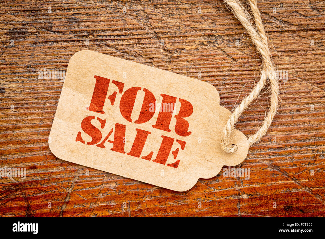 for sale sign a paper price tag against rustic red painted barn wood ...
