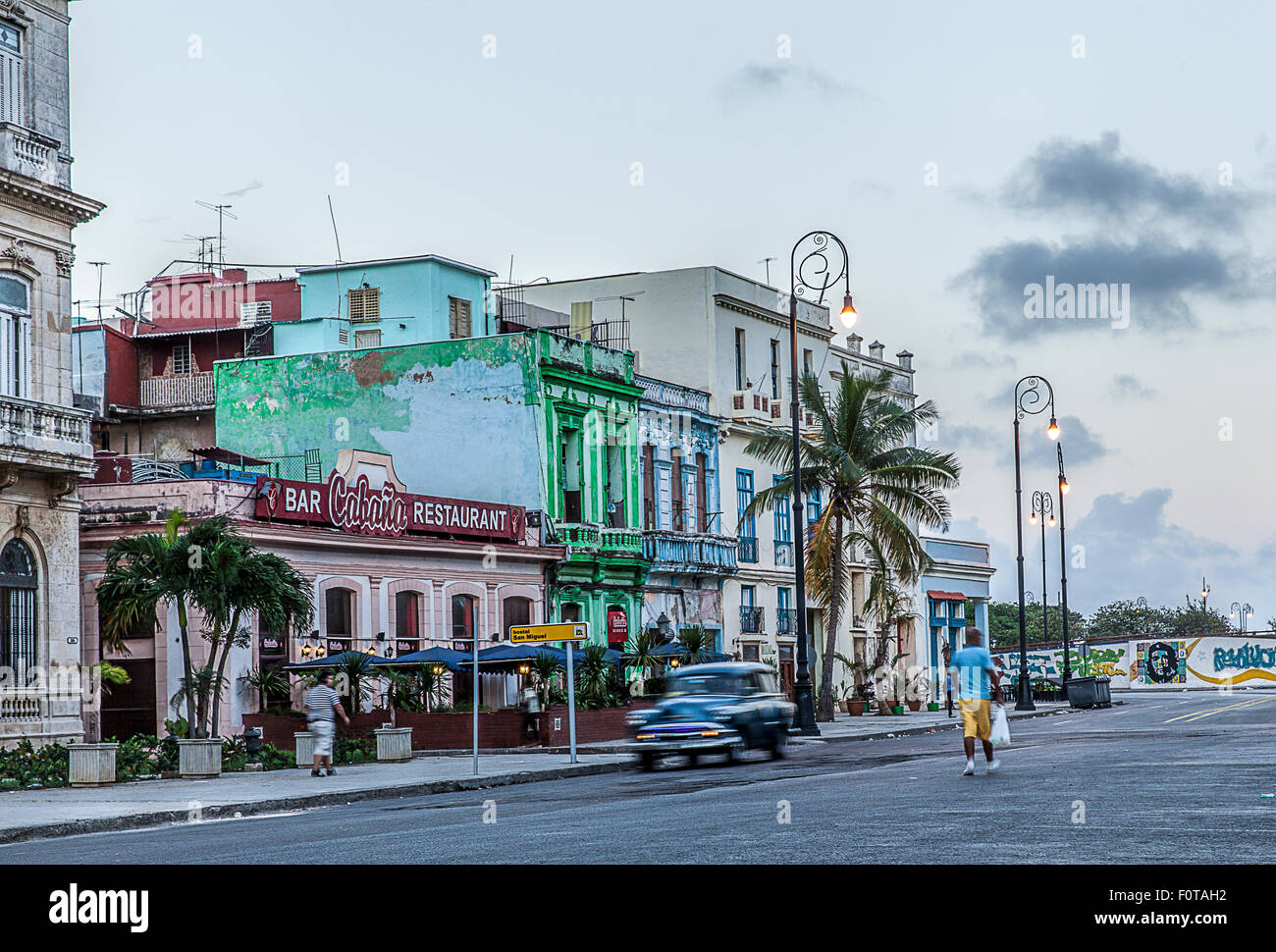 Brightly coloured pastel shaded buildings on the seafront at Malecon in ...