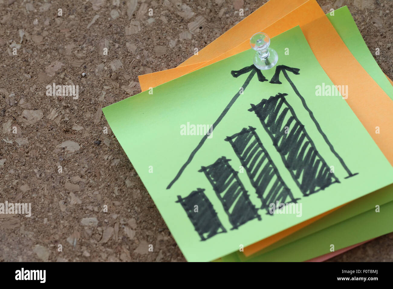 close up of pin and hand drawn business strategy graph chart on sticky ...