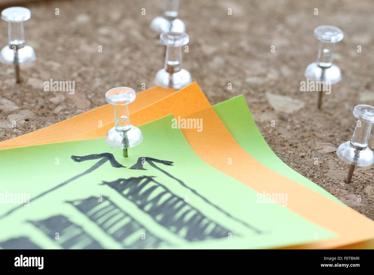close up of pin and hand drawn business strategy graph chart on sticky ...