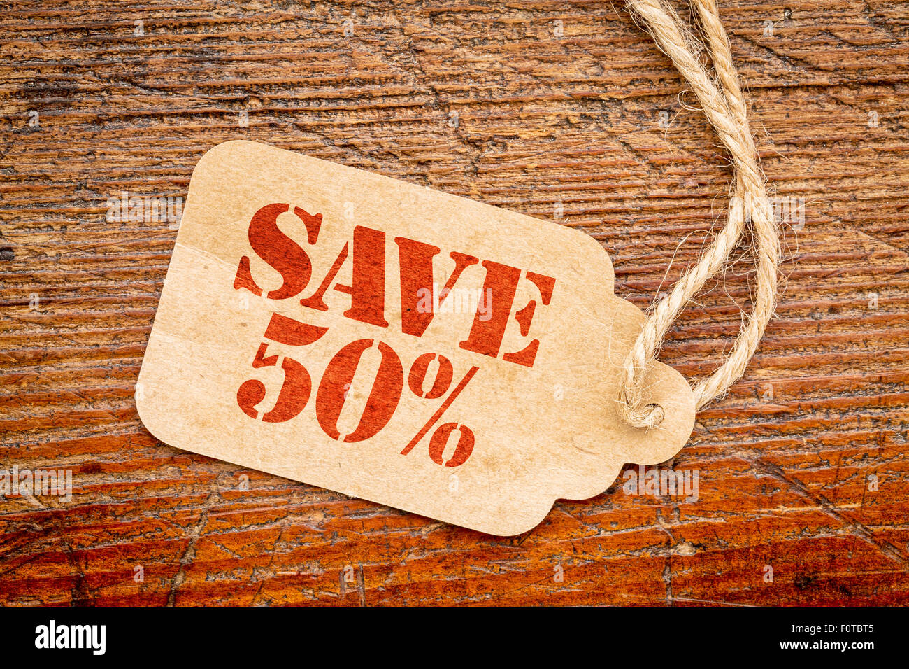 save 50 percent sign a paper price tag against rustic red painted barn ...
