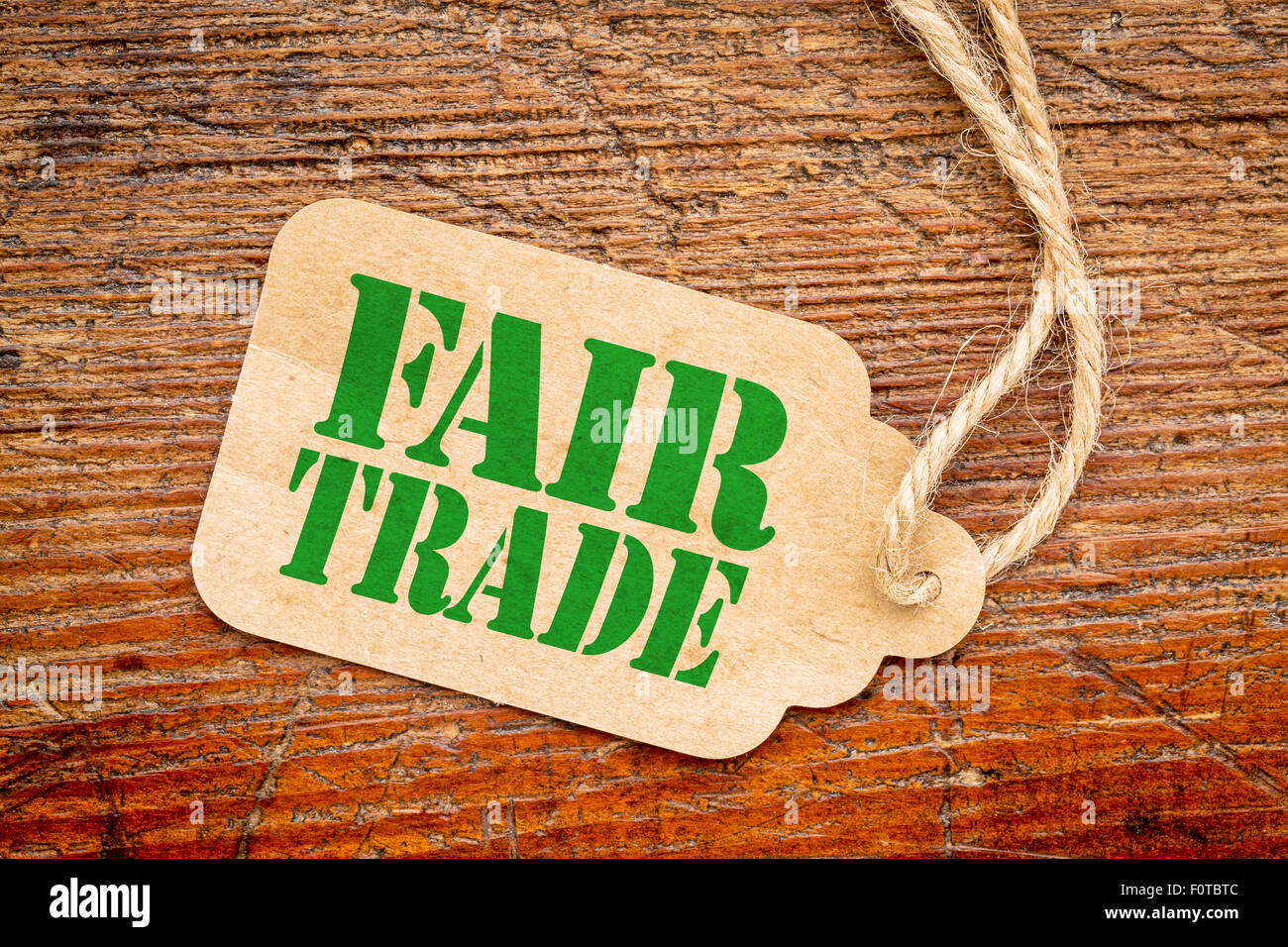 fair trade sign a paper price tag against rustic red painted barn wood ...