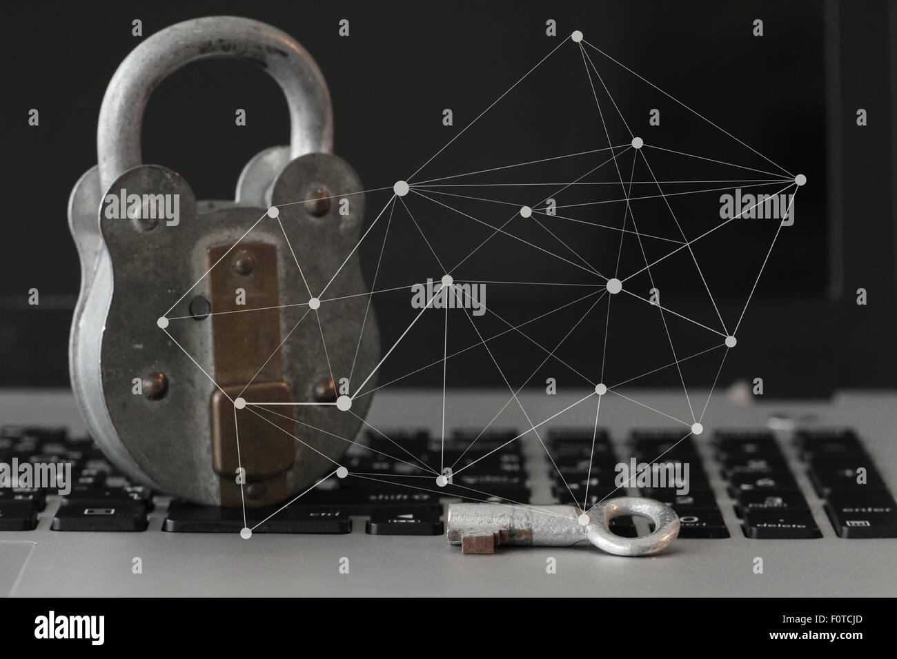 Internet security concept-old padlock and key on laptop computer ...