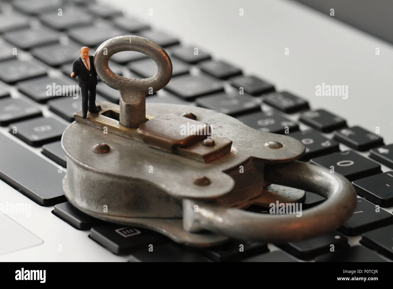 Internet security concept-old padlock and key on laptop computer ...