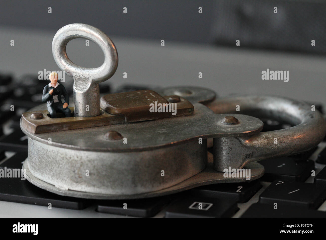Internet security concept-old padlock and key on laptop computer ...