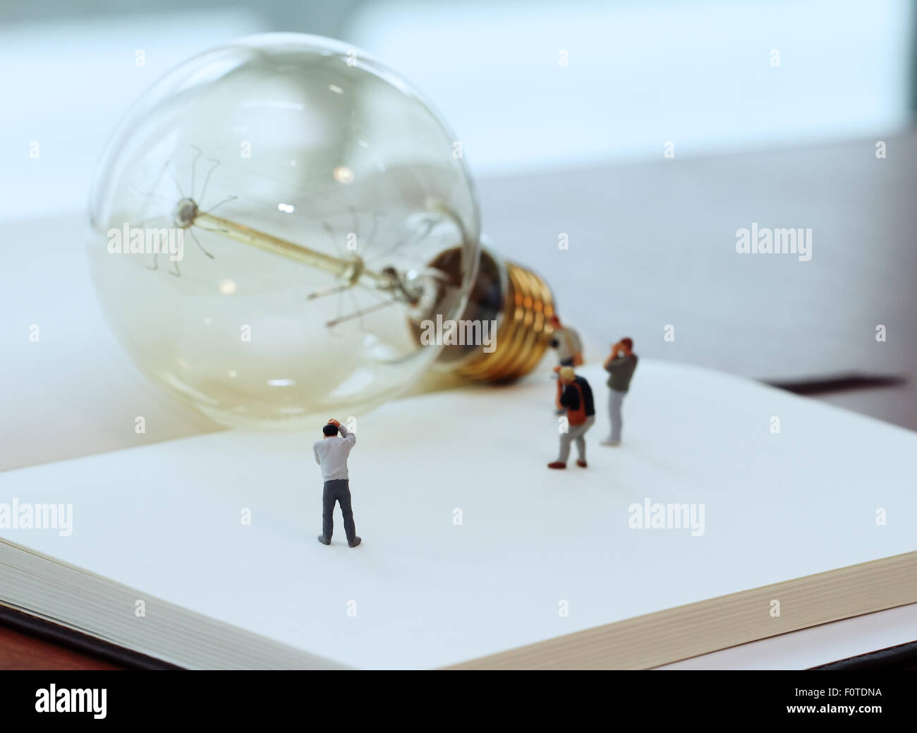 Creative idea concept - miniature photographer with vintage light bulb ...