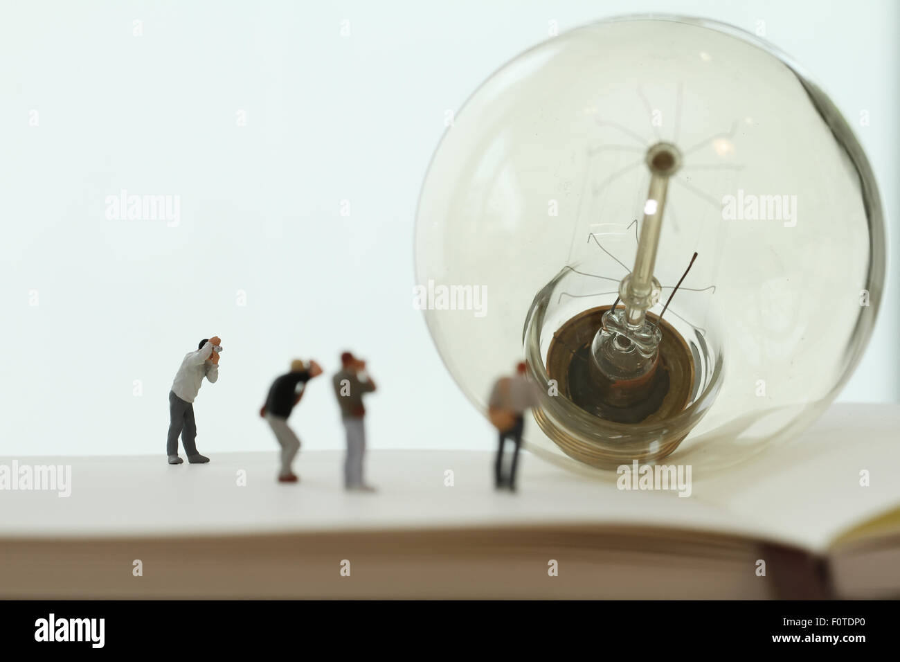 Creative idea concept - miniature photographer with vintage light bulb ...