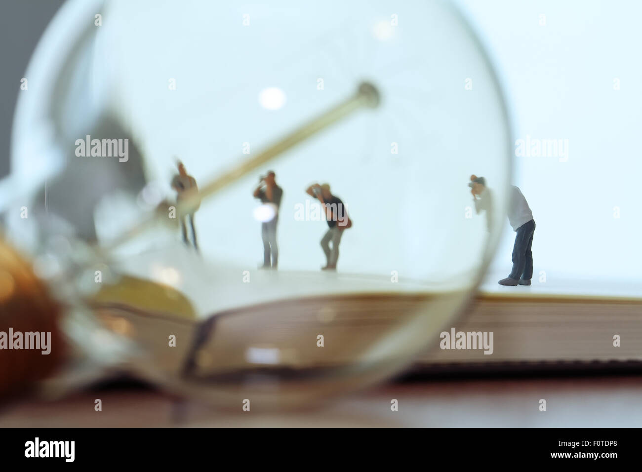 Creative idea concept - miniature photographer with vintage light bulb ...