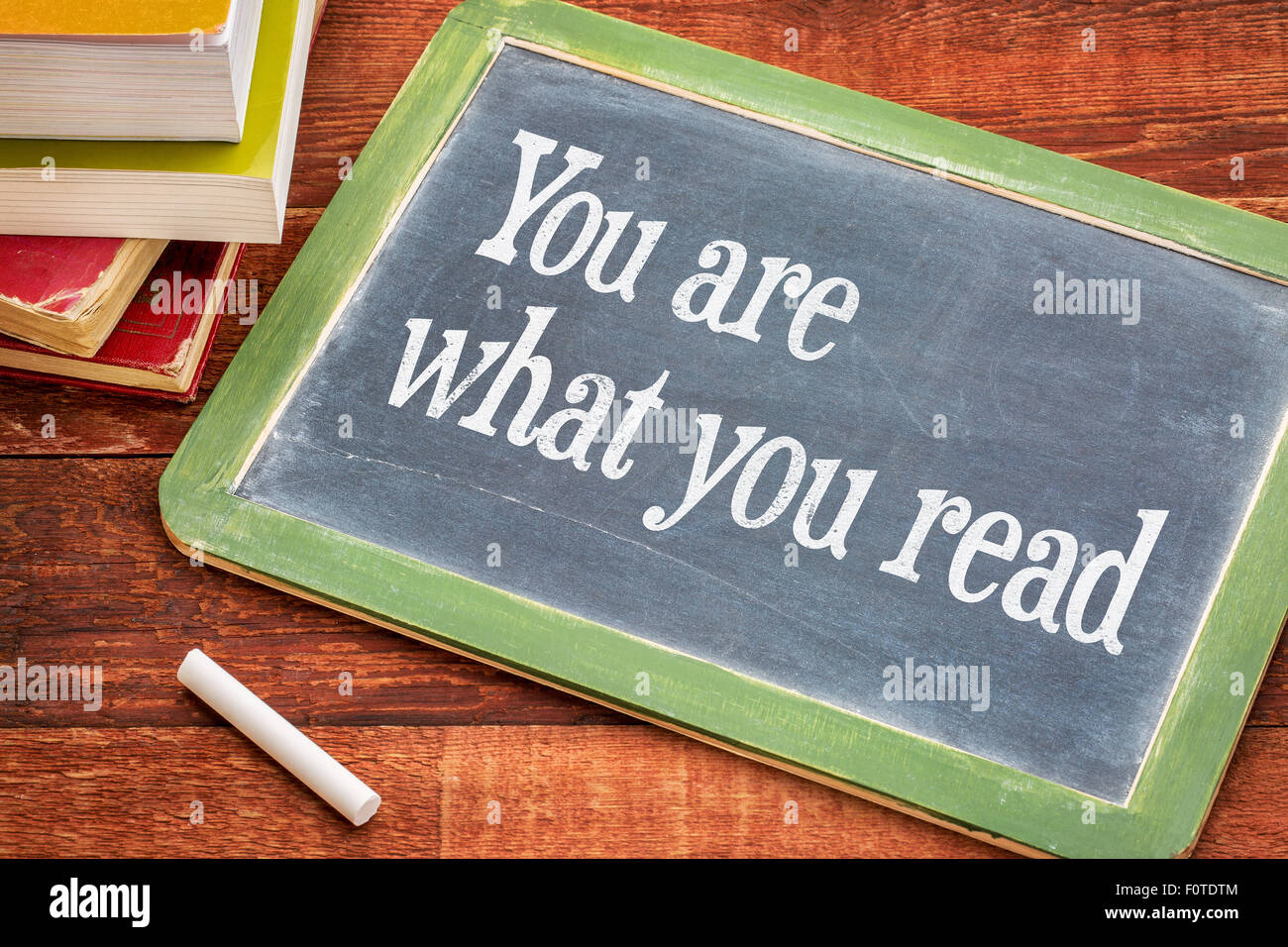 You are what you read - motivational phrase on a slate blackboard with ...