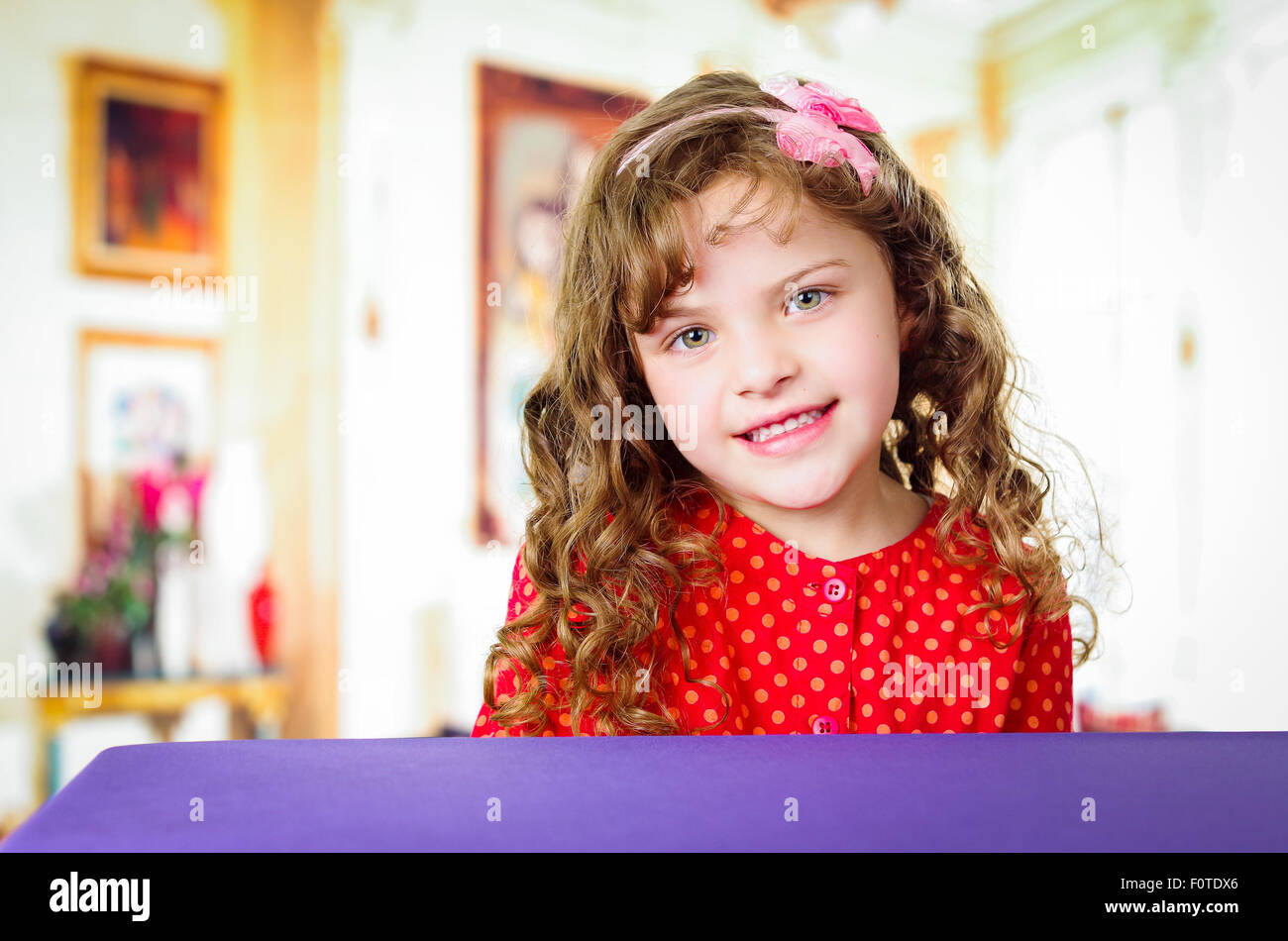Beautiful preschooler girl sitting at the table Stock Photo - Alamy